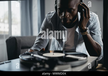 African american man playing vinyl record at home Stock Photo - Alamy