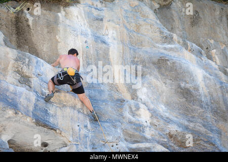 Young man rock climbing on a limestone wall Stock Photo - Alamy