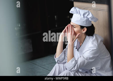 chef crying and sitting on floor at restaurant kitchen Stock Photo - Alamy