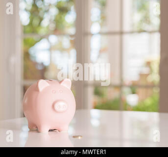 Pink piggy bank on wood office desk table. Saving money wealth and ...