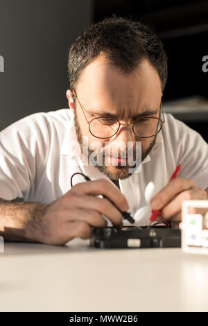 man using multimeter while testing hard disk drive Stock Photo - Alamy