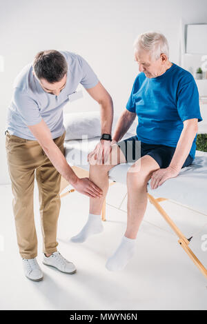 Senior therapist with grey hair doing online session at consultation ...