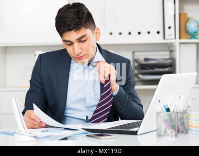 Male professional is having complicated issue in project in office ...