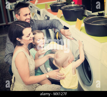 Home laundry. Smiling russian girl using washing machine at home Stock ...