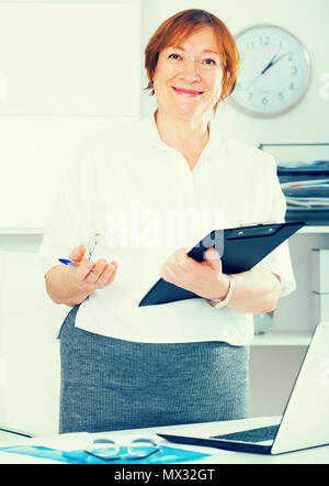 Smiling woman manager waiting for clients in her office Stock Photo - Alamy