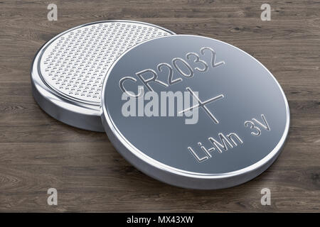 Button cells on the wooden table, 3D rendering Stock Photo - Alamy