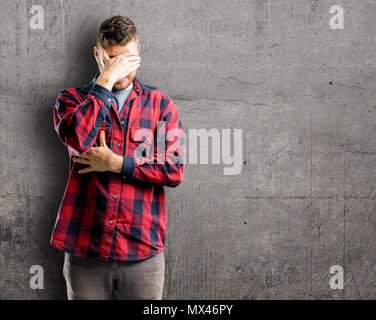 Handsome blond man stressful keeping hands on head, tired and ...