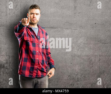 Handsome young man pointing to the front with finger Stock Photo - Alamy