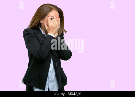 Middle age hispanic woman having eyebrows treatment at beauty center ...