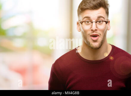 Handsome young man scared in shock, expressing panic and fear Stock ...