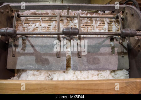 Wool carding; brushing of wool fibres with wire teeth to align the ...