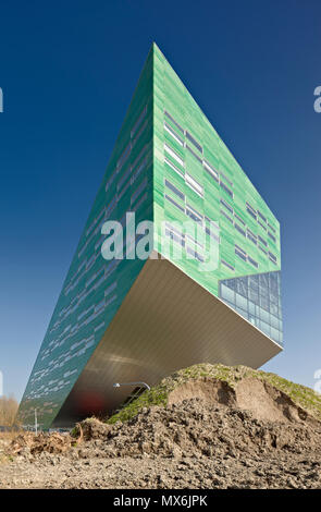 Blue university building in Groningen, with a autumn coloured tree on ...