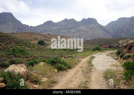 Dirt road on the slope of mount in Crete, Greece Stock Photo - Alamy