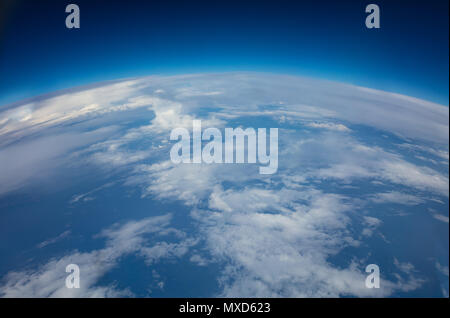 Curvature of planet earth. Aerial shot. Blue sky and clouds over island ...
