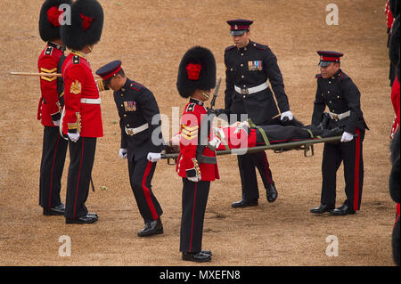 A soldier, overcome with heat, collapses and is stretchered off the ...