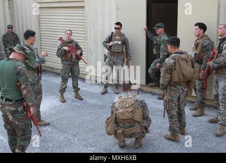 Marine critical skills operators conduct an after action debrief with ...