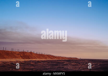 The sun sets on the perimeter berm at Qayyarah West Airfield, Iraq, Nov ...