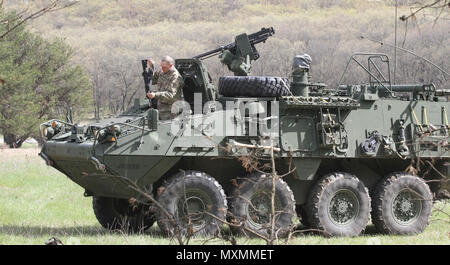 From the hatch of a Stryker vehicle, Spc. Brian Weinberger, secures his ...