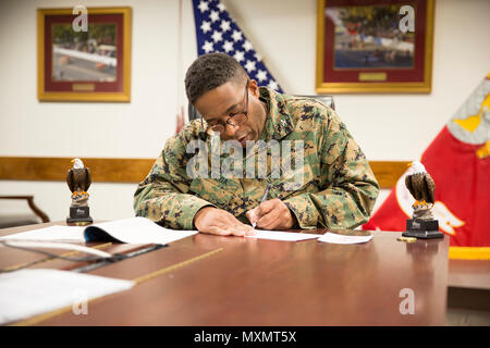 U.S. Marine Col. Sekou S. Karega, left, commanding officer of Camp ...