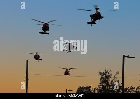 An AH-64D apache leads a 5 helicopter formation flight as they fly ...