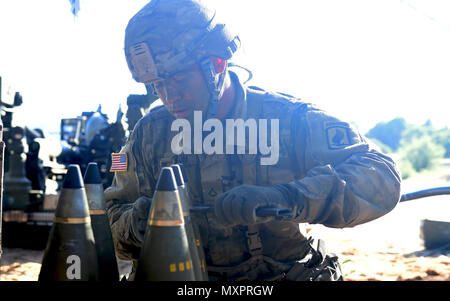U.S. Army paratroopers prepare 155mm rounds for firing with M777A2 ...