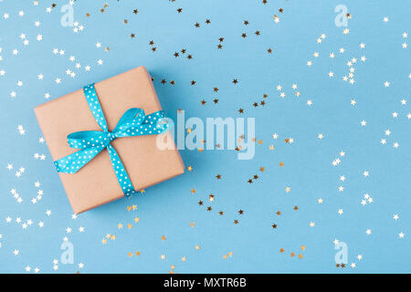 Gift box with turquoise ribbon is tied with bow Stock Photo - Alamy
