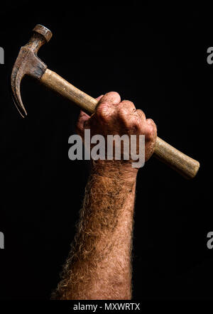A man's arm raised holding a hammer isolated on white background Stock ...