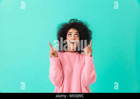 Woman pointing both index fingers upward on a soccer stadium field in ...