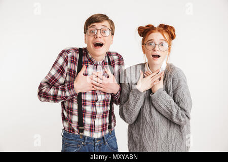 Excited couple of school nerds looking at camera isolated over white ...