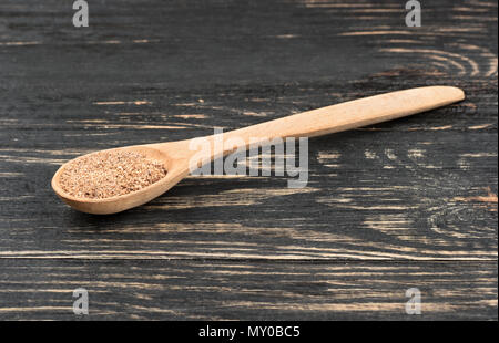Nutmeg powder in spoon on wooden background, top view Stock Photo - Alamy