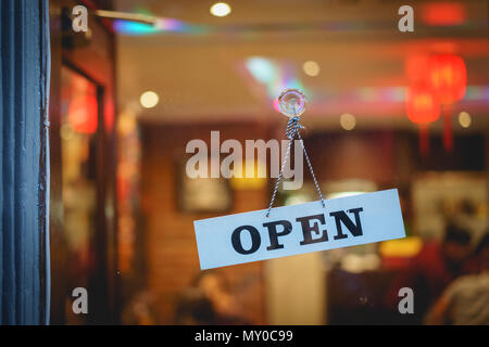 Open signboard on a coffee shop door with a white wooden frame ...