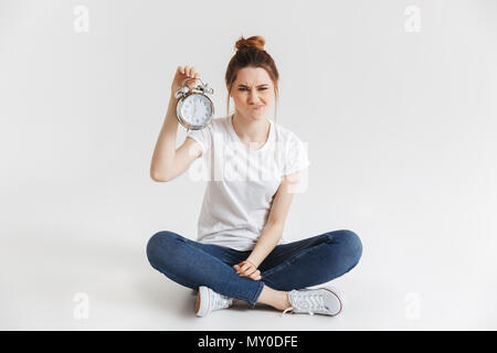 Beautiful female legs and an alarm clock in the morning Stock Photo - Alamy