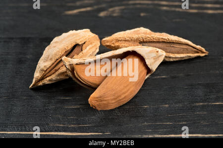 Wild uzbek inshell almonds on wooden background Stock Photo - Alamy