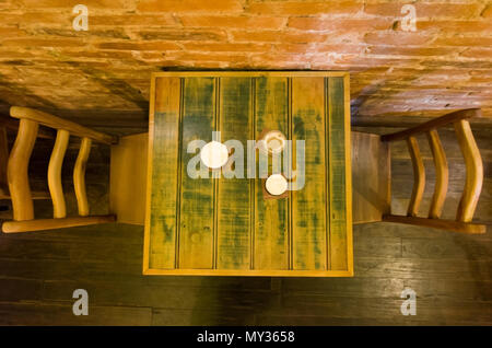 Wooden kitchen table and chairs viewed through stone arch Stock Photo ...