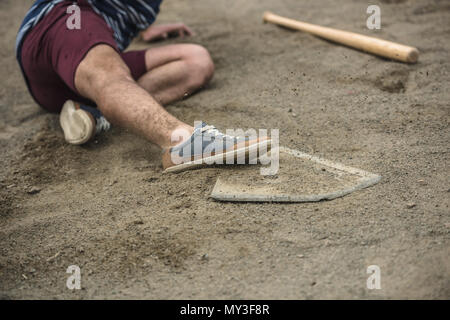 baseball player reaching base during game on court Stock Photo - Alamy