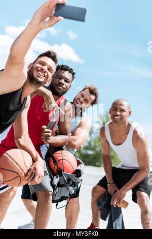 Basketball players taking a selfie Stock Photo - Alamy