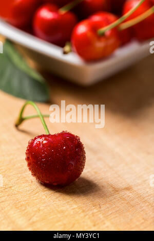 Bowls with tasty ripe cherry on color background Stock Photo - Alamy