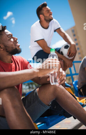 Side view of American football players on field Stock Photo - Alamy