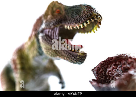 dinosaur bloody body and a tyrannosaurus at background selective focus ...