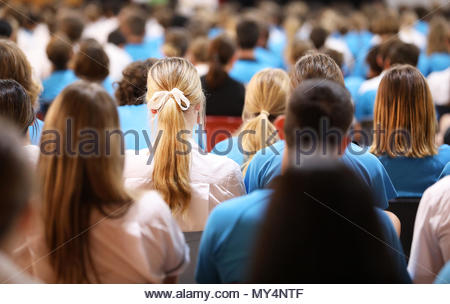 Junior high school students listen to a speaker during a field trip ...