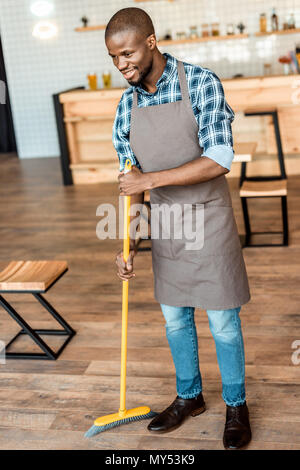 handsome African American man sweeping on white background Stock Photo ...