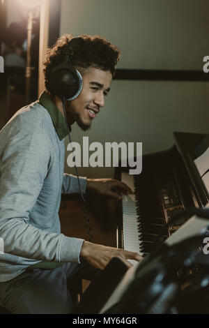 Young african american man playing trumpet puffing cheeks with funny ...