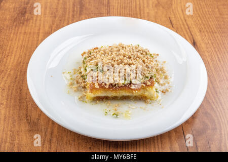 turkish dessert kunefe on kaymak, cream slide with pistachio powder ...