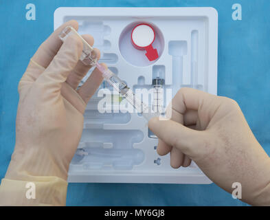 Injection of spinal anesthesia in preparation for surgery. The hands of ...