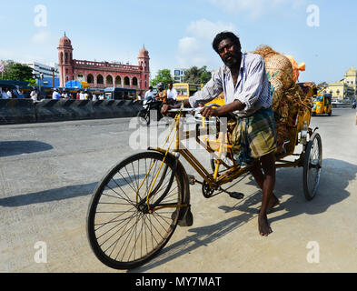 Man transporting goods on a cycle rickshaw through city of Dhaka ...
