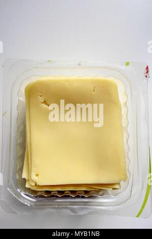A view a stack of processed cheese slices, individually wrapped in ...