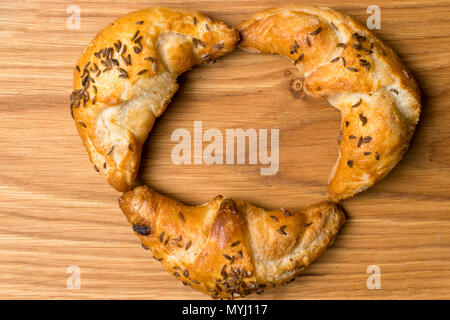 baked rolls with cumin seeds close up on wooden background Stock Photo ...