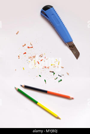 Pencil with cutter knife with shavings, on blank white sheet of paper ...