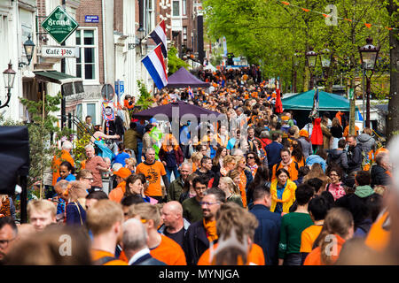 Crowd of people on the street celebrate King's day in Amsterdam city ...