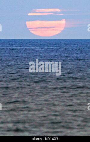 Teignmouth, Devon, UK. 26th May 2021. Full Flower moon rises over the ...
